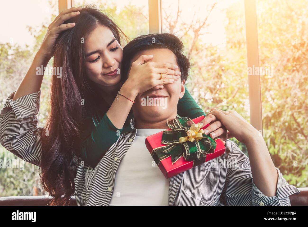Happy couple giving gift present to celebrate Stock Photo - Alamy