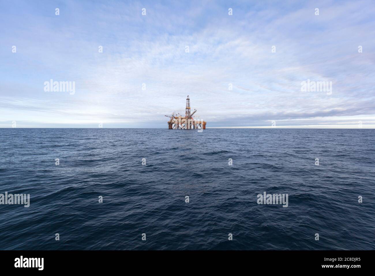 Oil rig at sunset time Stock Photo - Alamy