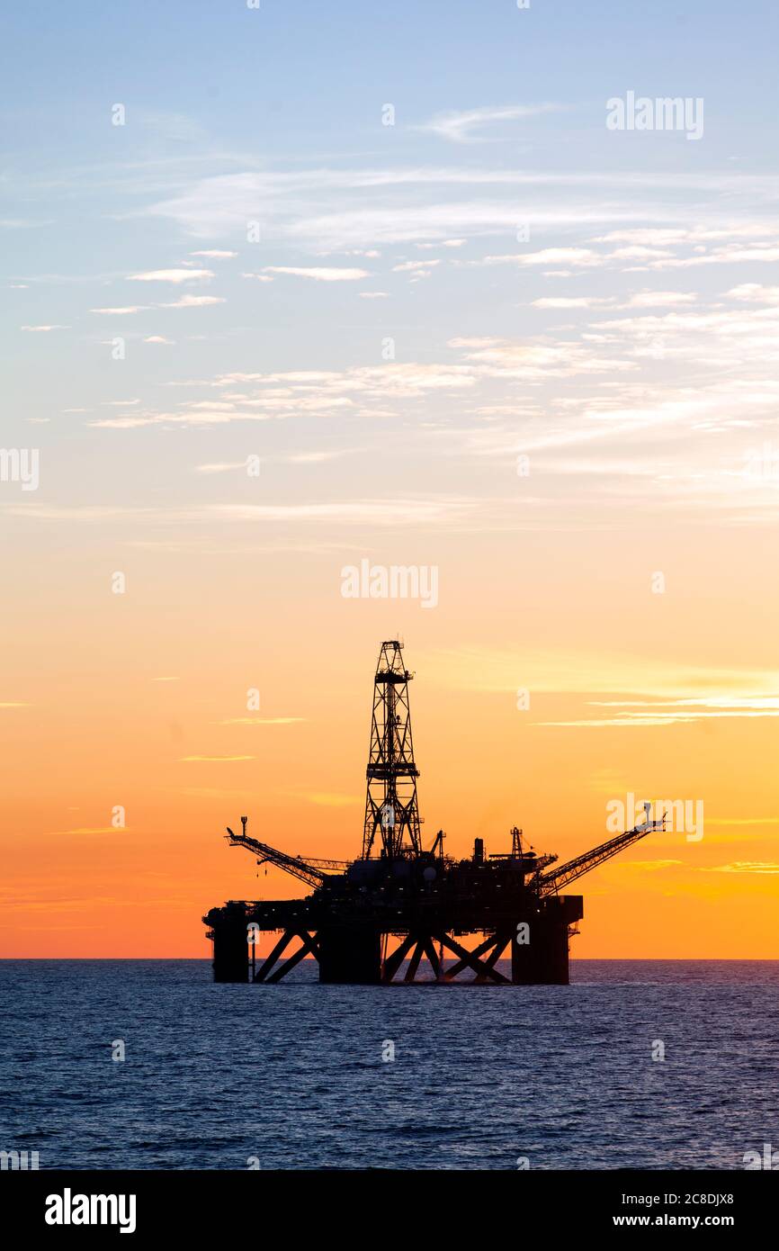 Oil rig at sunset time Stock Photo - Alamy