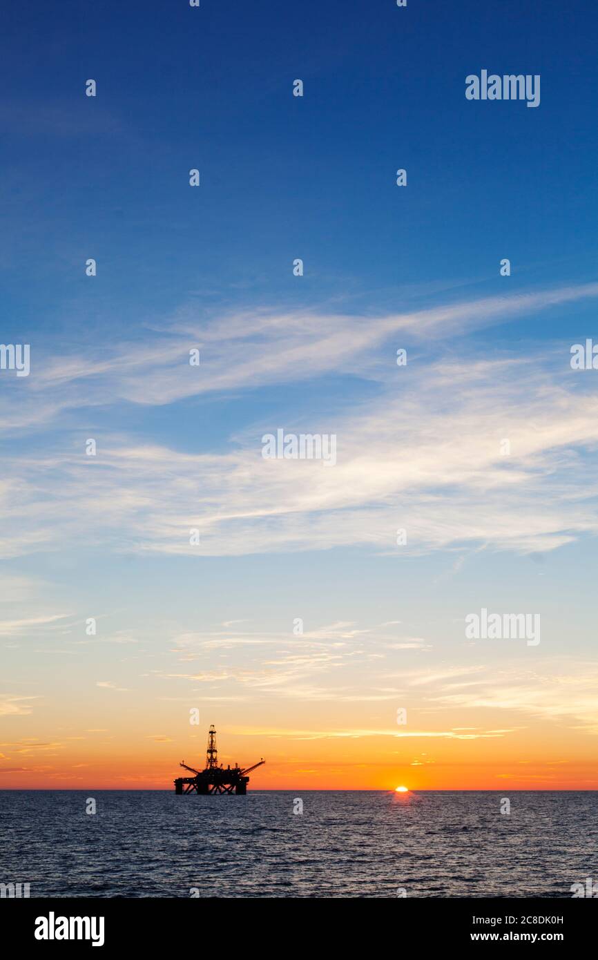 Oil rig at sunset time Stock Photo - Alamy
