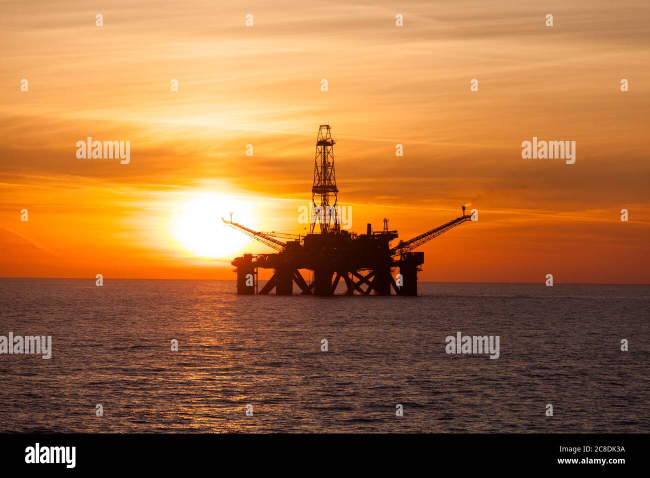 Oil rig at sunset time Stock Photo - Alamy