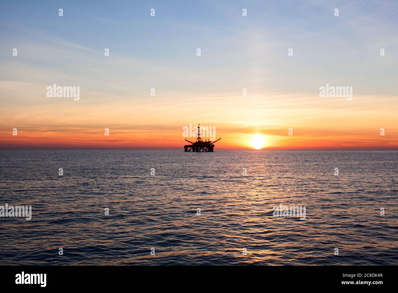 Oil rig at sunset time Stock Photo - Alamy