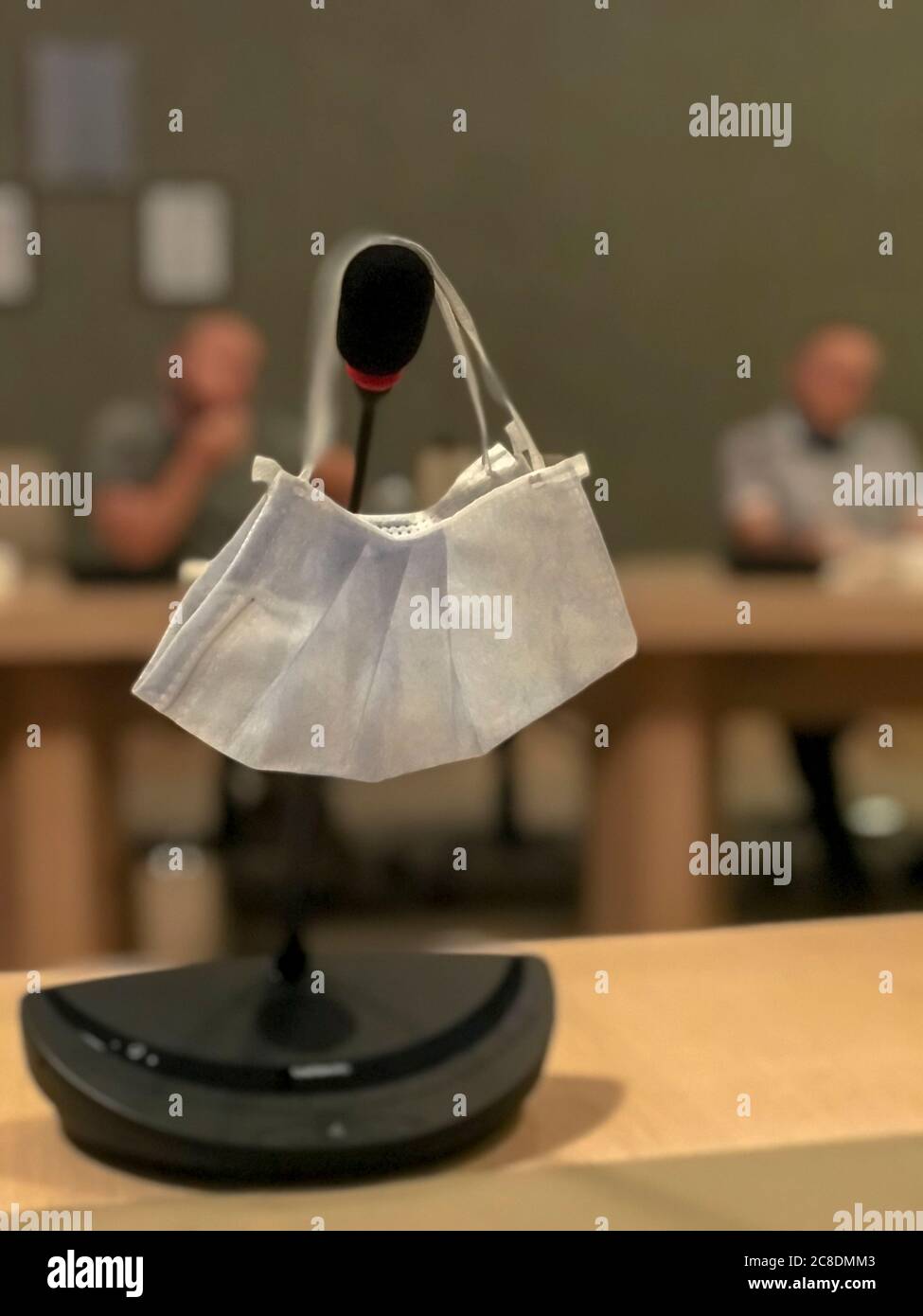 Meeting and mask hung on microphone Stock Photo - Alamy