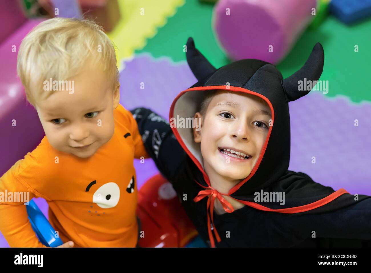 Cute adorable caucasian kid boy in devil costume having fun laughing ...