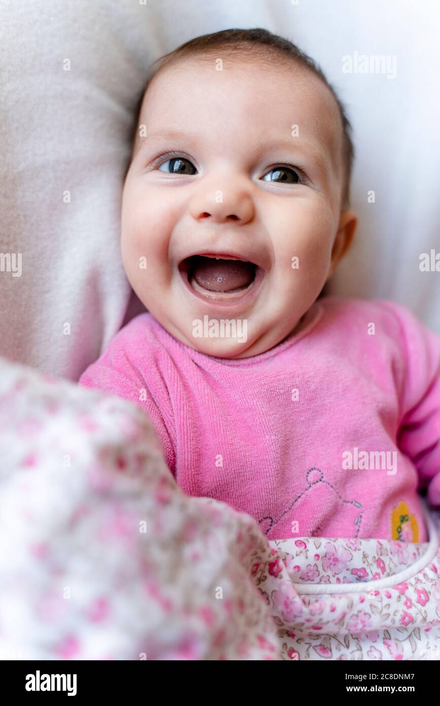 Cheerful girl lying on bed hi-res stock photography and images - Alamy
