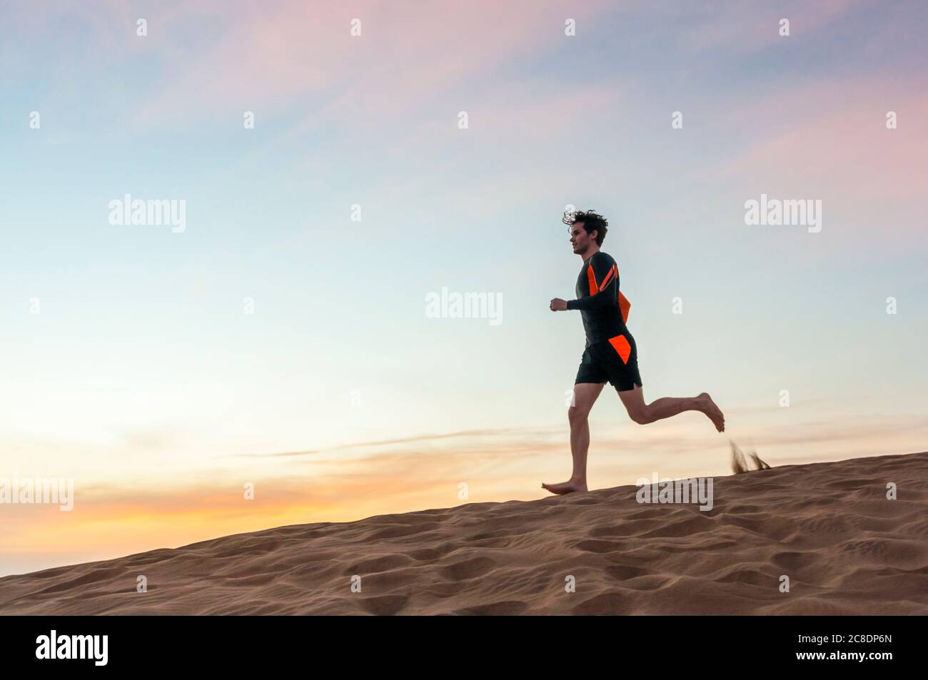 Man running at sunset in the dunes hi-res stock photography and images ...