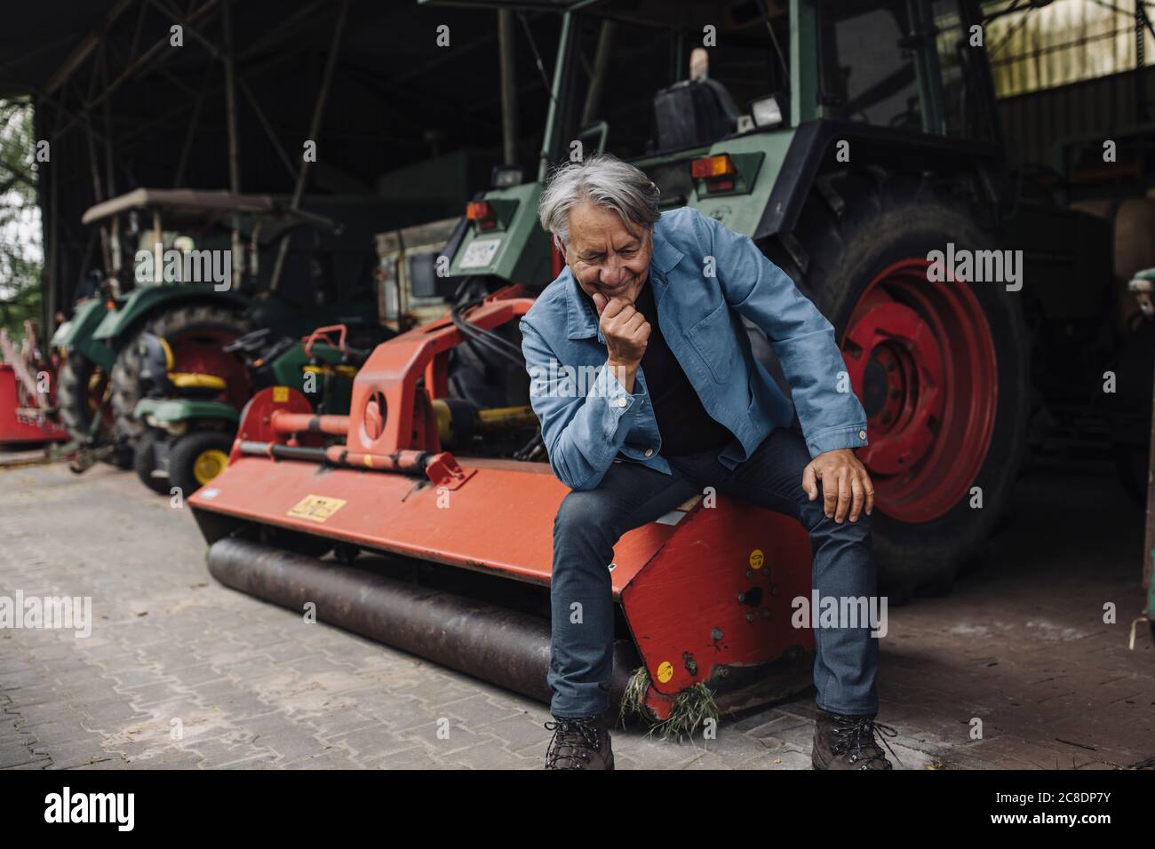Farmer sitting on a tractor hi-res stock photography and images - Alamy