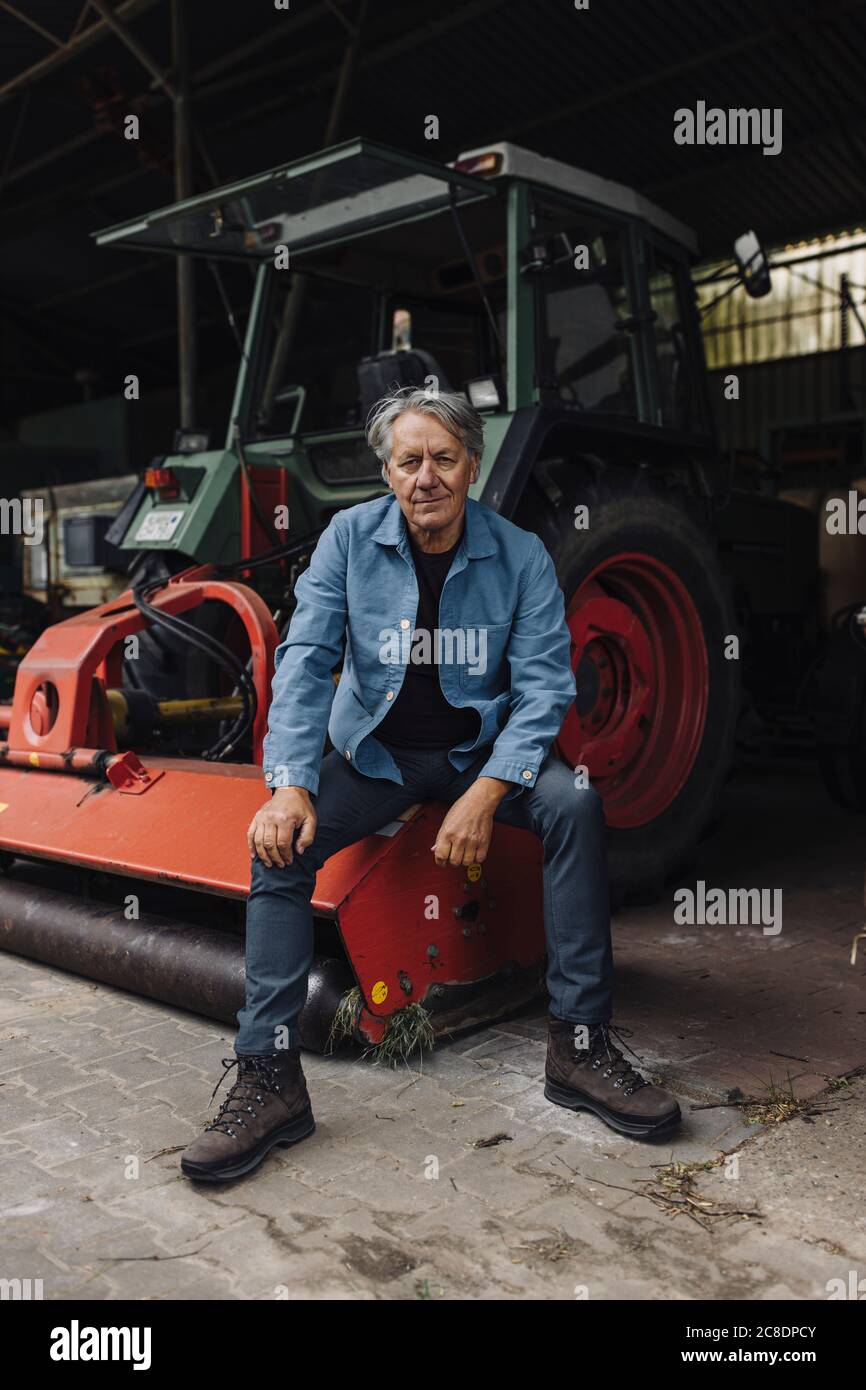 Farmer sitting on a tractor hi-res stock photography and images - Alamy