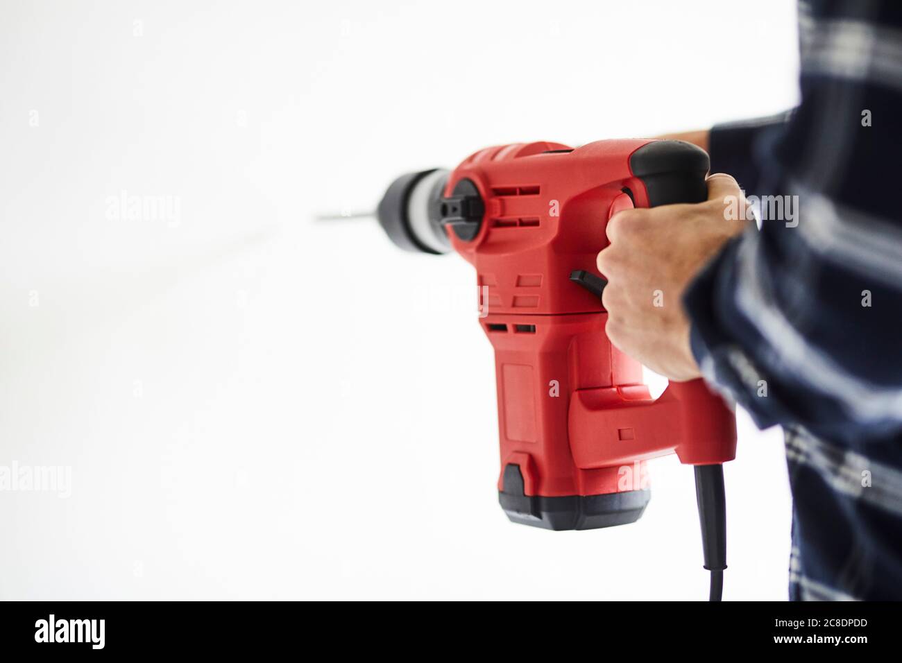 Young man drilling wall hi-res stock photography and images - Alamy