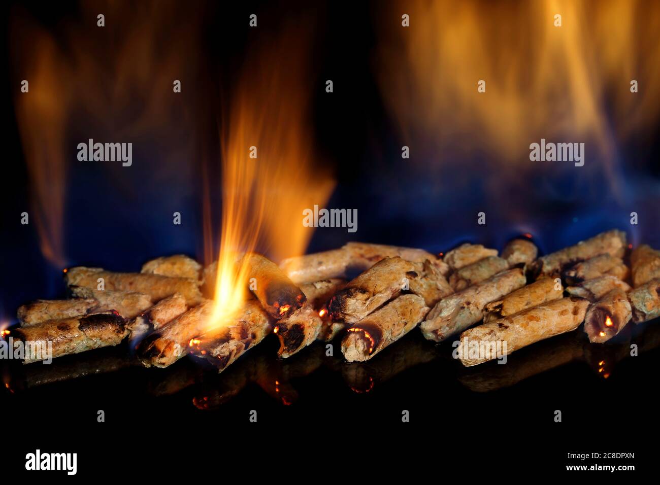 amount of burning wood pellets closeup Stock Photo - Alamy
