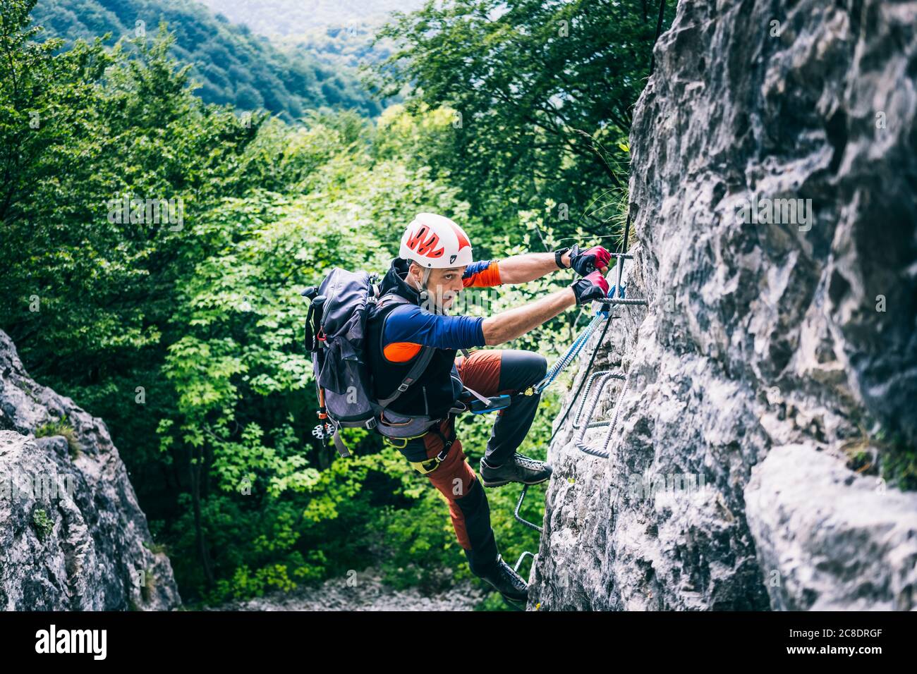 Mountaineer climbing on via ferrata, Orobie, European Alps, Como, Italy ...