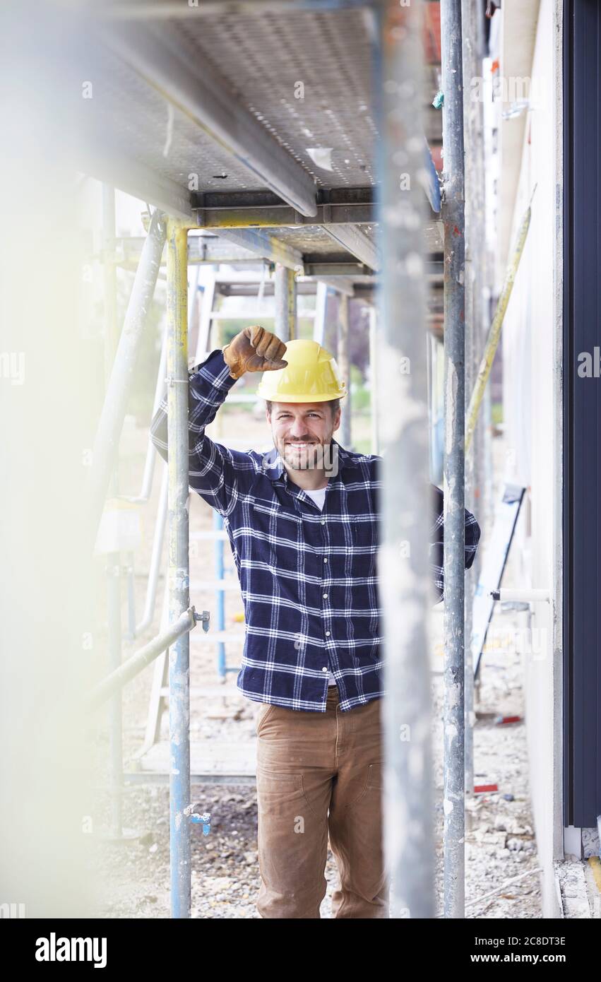 Portrait of smiling worker standing on a construction site Stock Photo ...