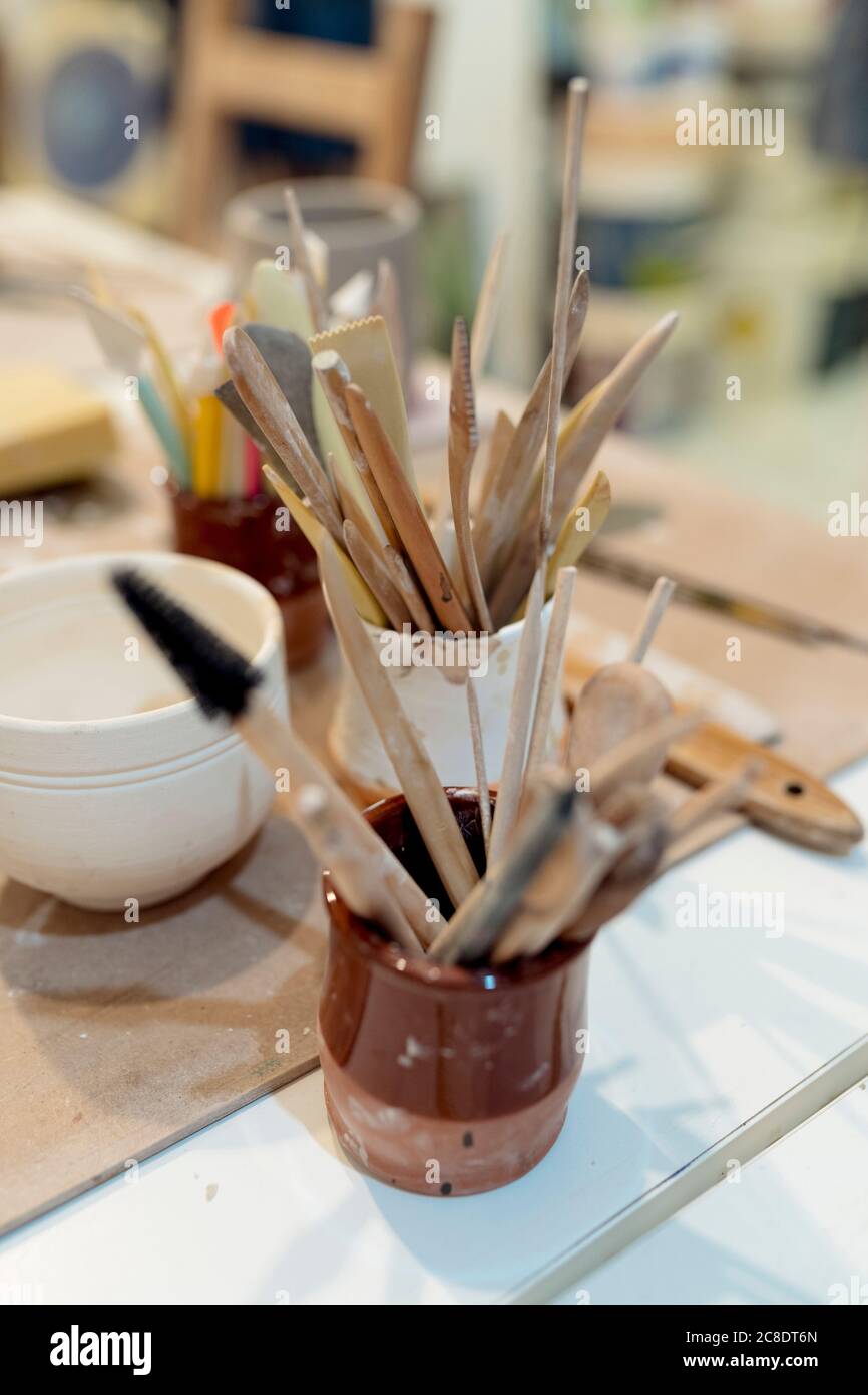 Close-up of brushes in desk organizers on workbench in studio Stock ...