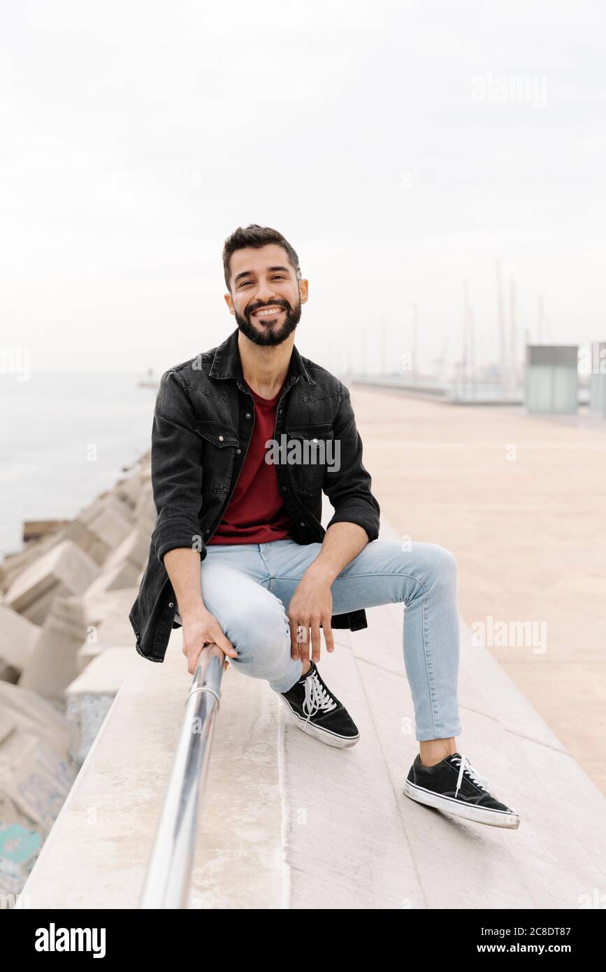 Man sitting on railing hi-res stock photography and images - Alamy