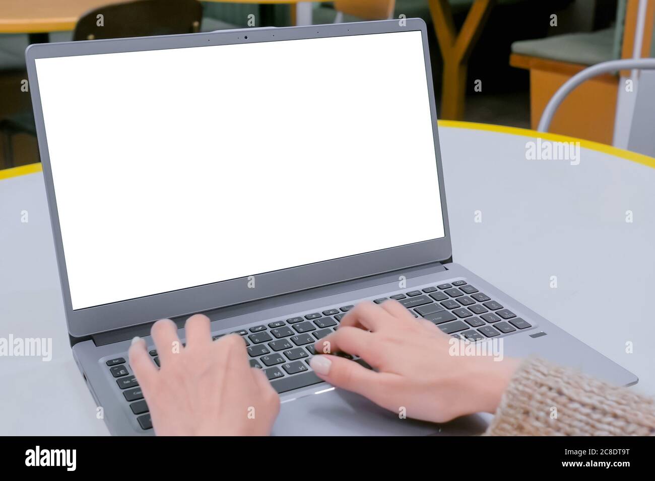 Mockup image: woman typing on laptop computer keyboard with white blank ...