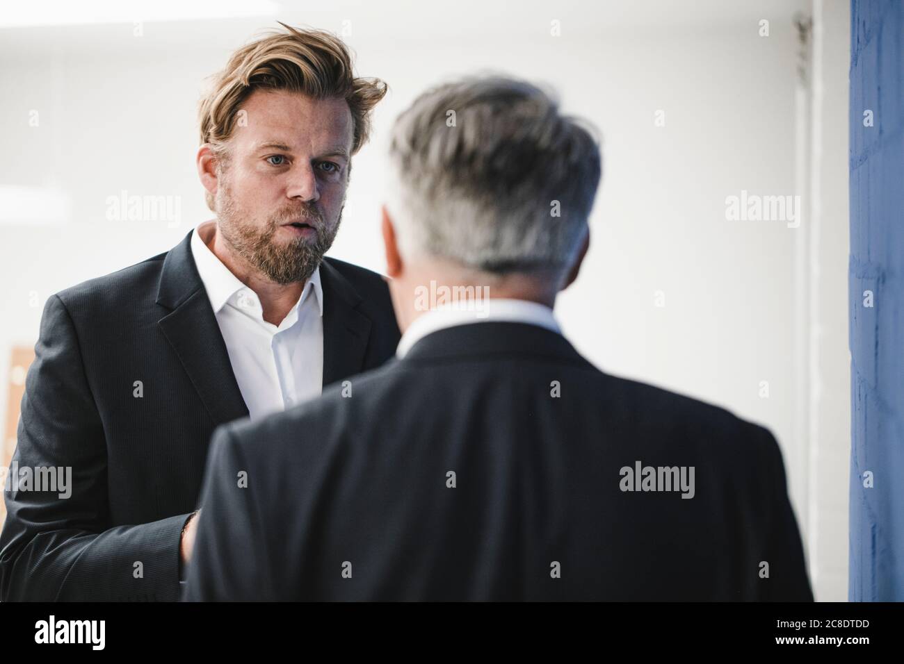 Two businessmen disussing in office Stock Photo - Alamy