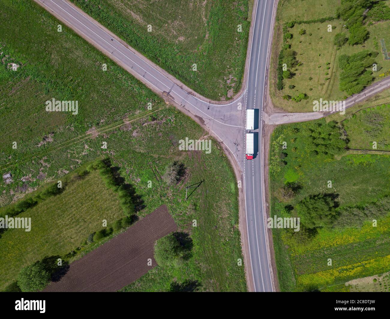 Aerial view of truck driving past intersection on country road hi-res ...