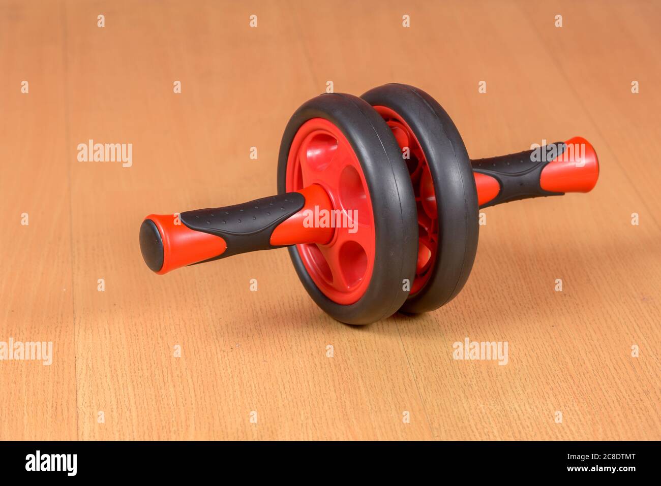 Portrait of ab wheel on wooden floor Stock Photo - Alamy