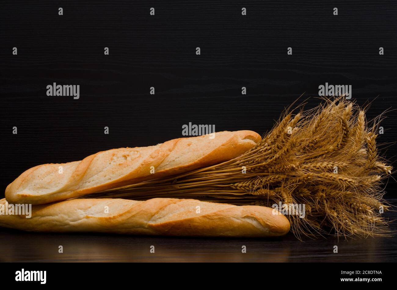 Sheaf and two white loaf on a black background, with space for text ...