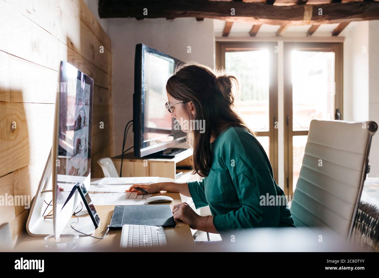 Female architect using computer at home Stock Photo - Alamy