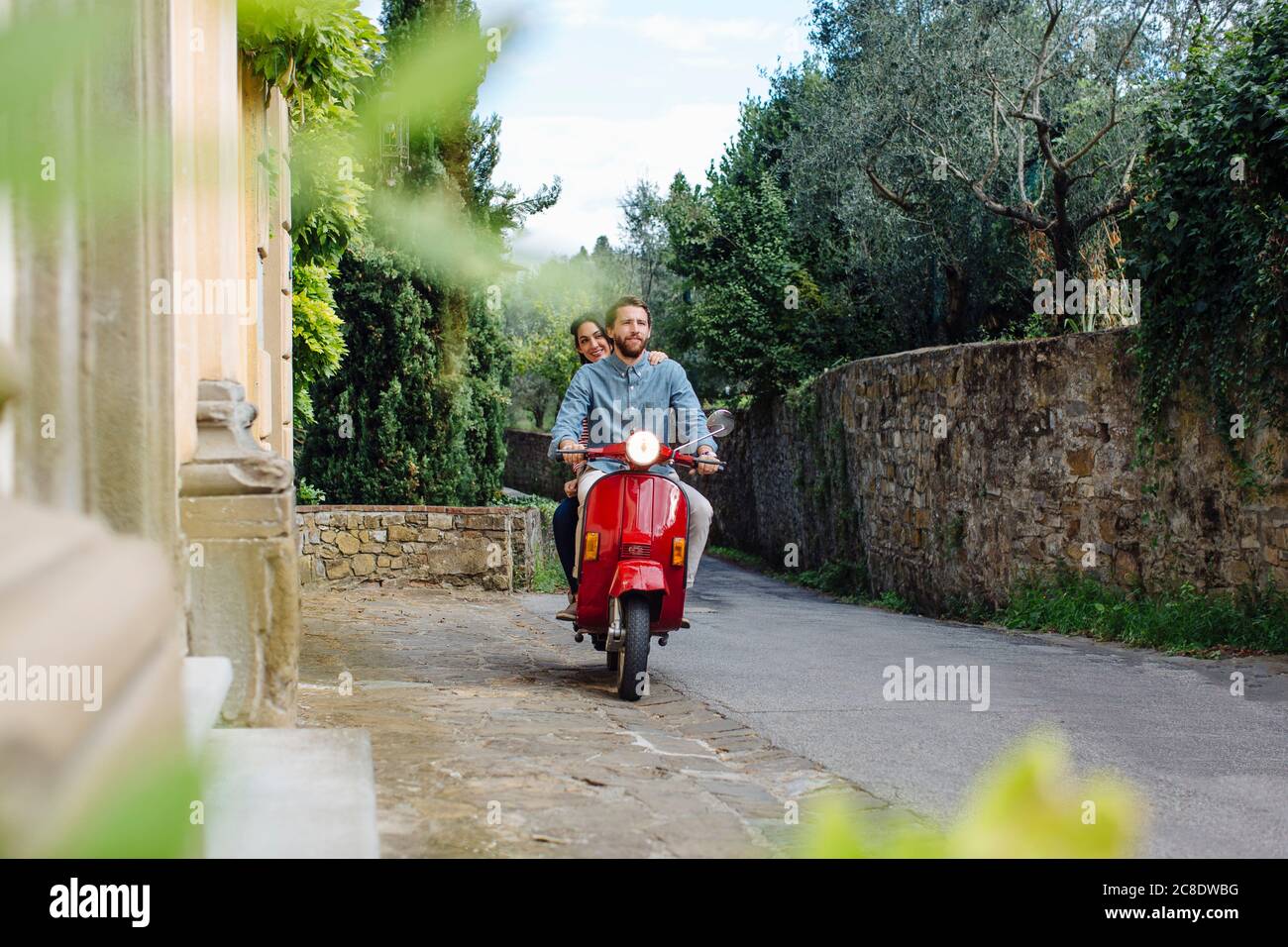 Man with girlfriend riding on Vespa Stock Photo - Alamy