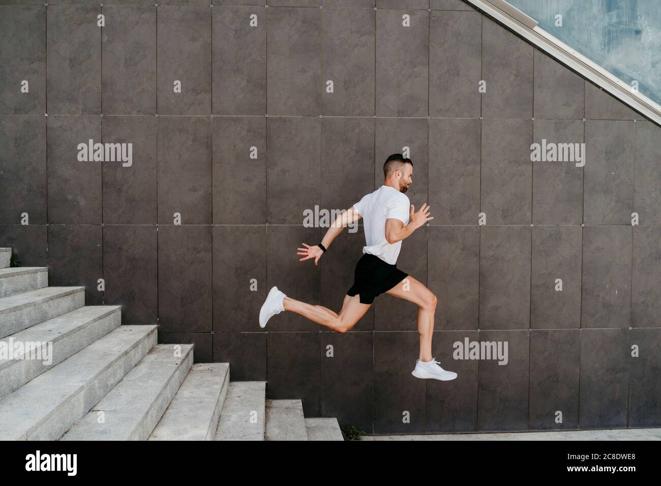 Male athlete running down stairs Stock Photo - Alamy