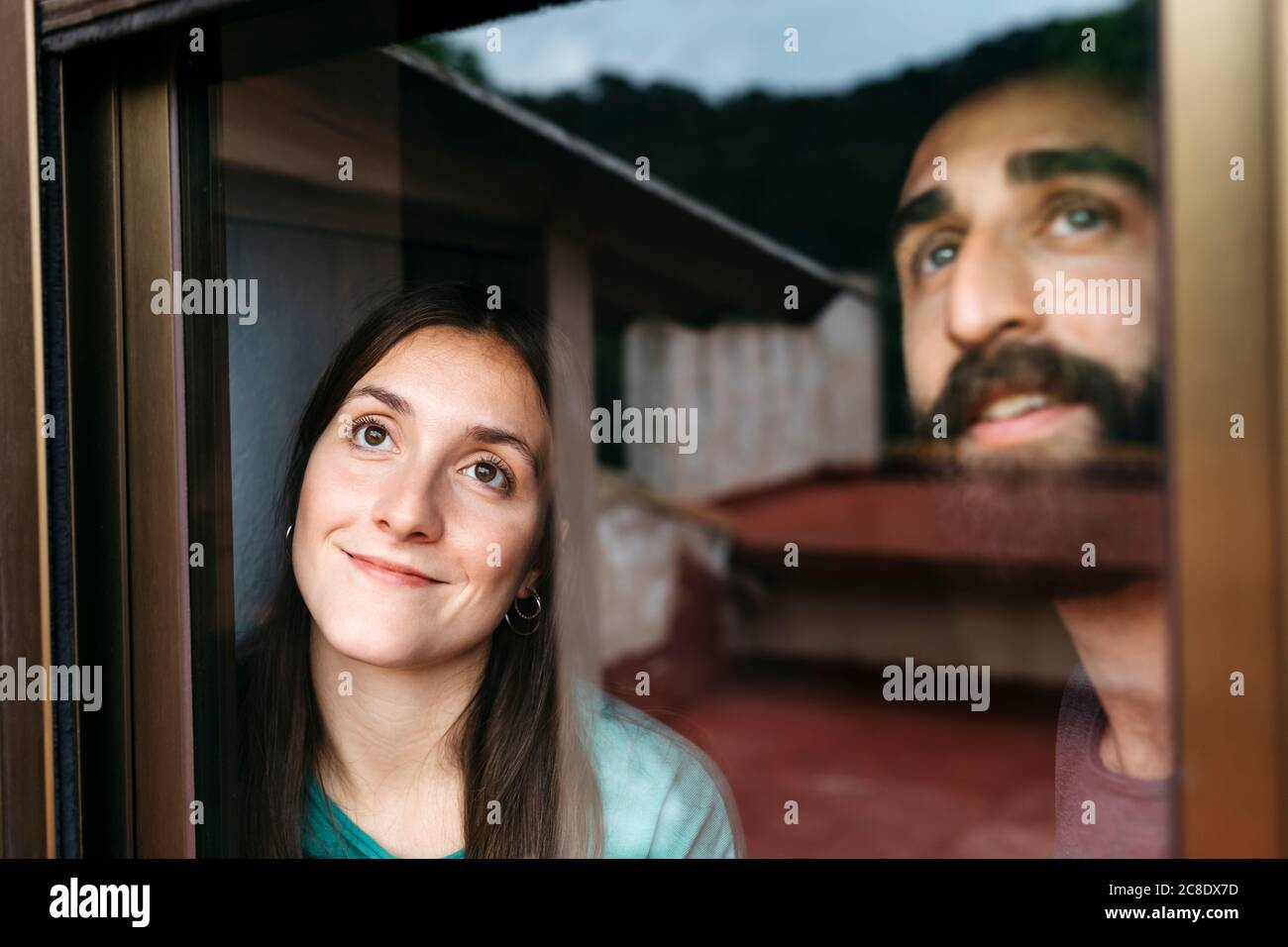 Couple looking out the window and thinking about the future Stock Photo ...