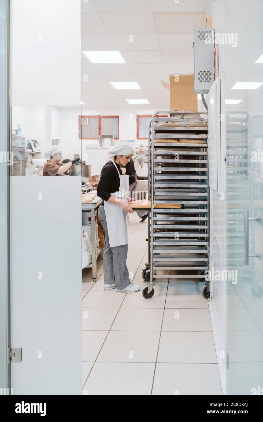 Bakers working at bakery Stock Photo - Alamy