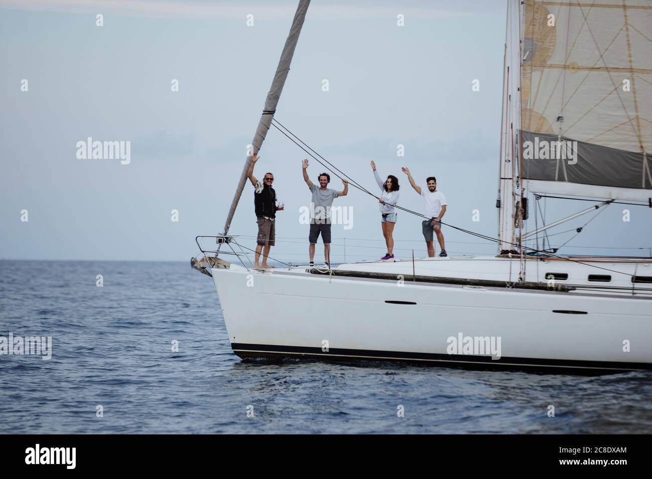 Woman waving at group friends hi-res stock photography and images - Alamy