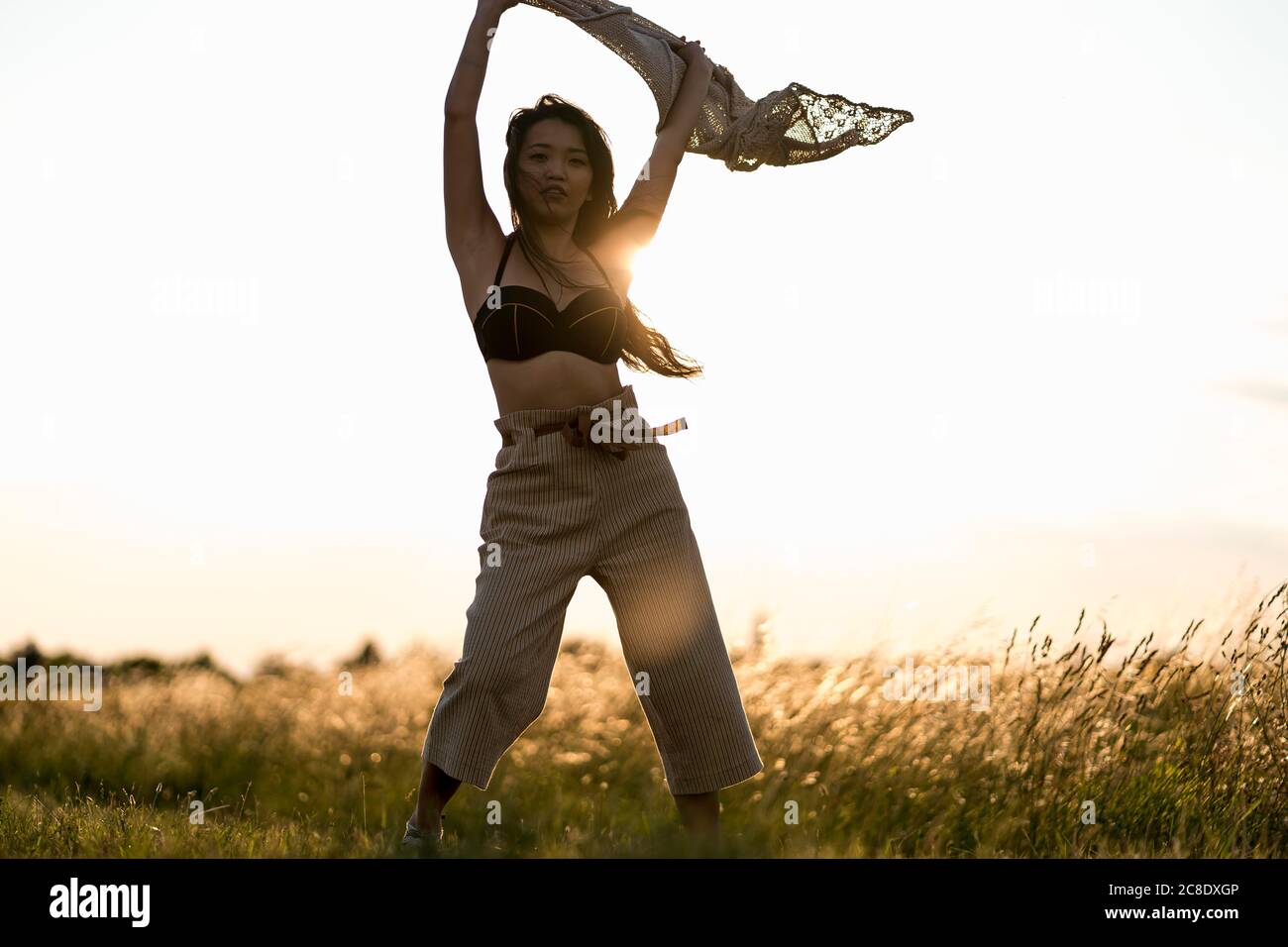 Woman dancing at field in the evening Stock Photo - Alamy