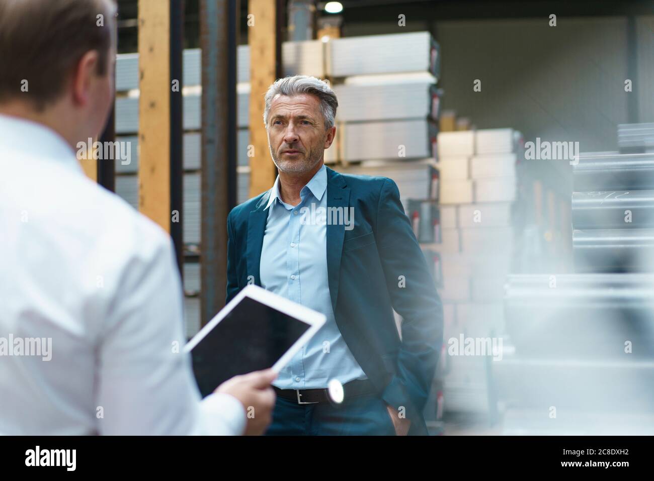 Two businessmen having a meeting in a factory Stock Photo - Alamy