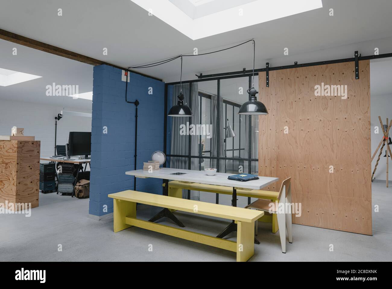 Table and benches in modern office Stock Photo - Alamy