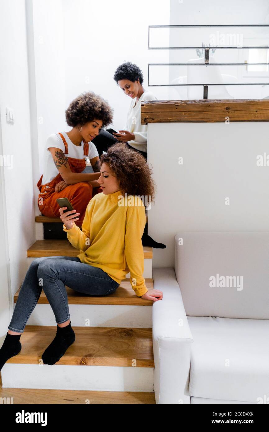Three friends sitting on couch hi-res stock photography and images - Alamy