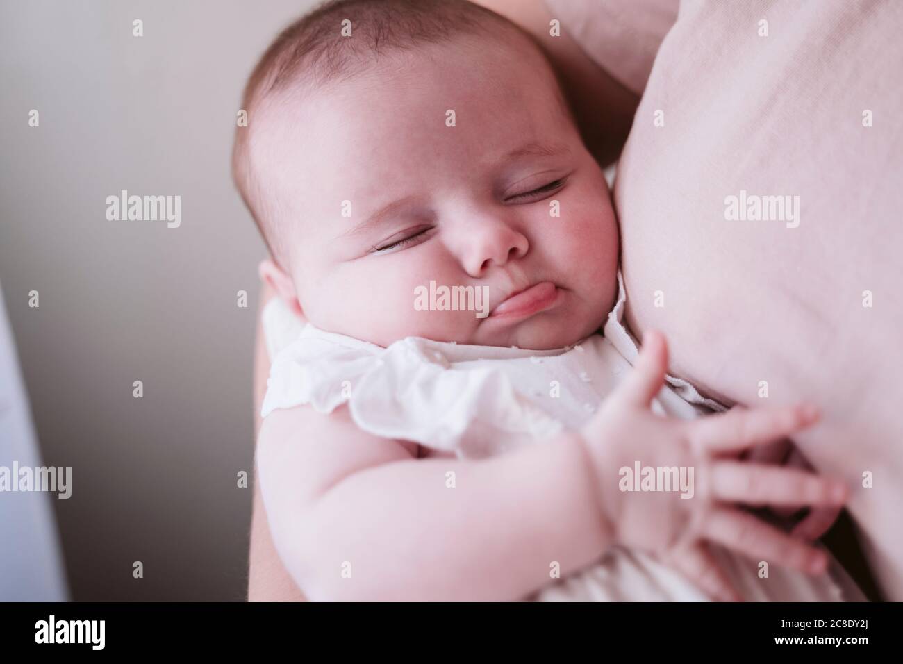 Cute baby girl being carried by mother at home Stock Photo - Alamy