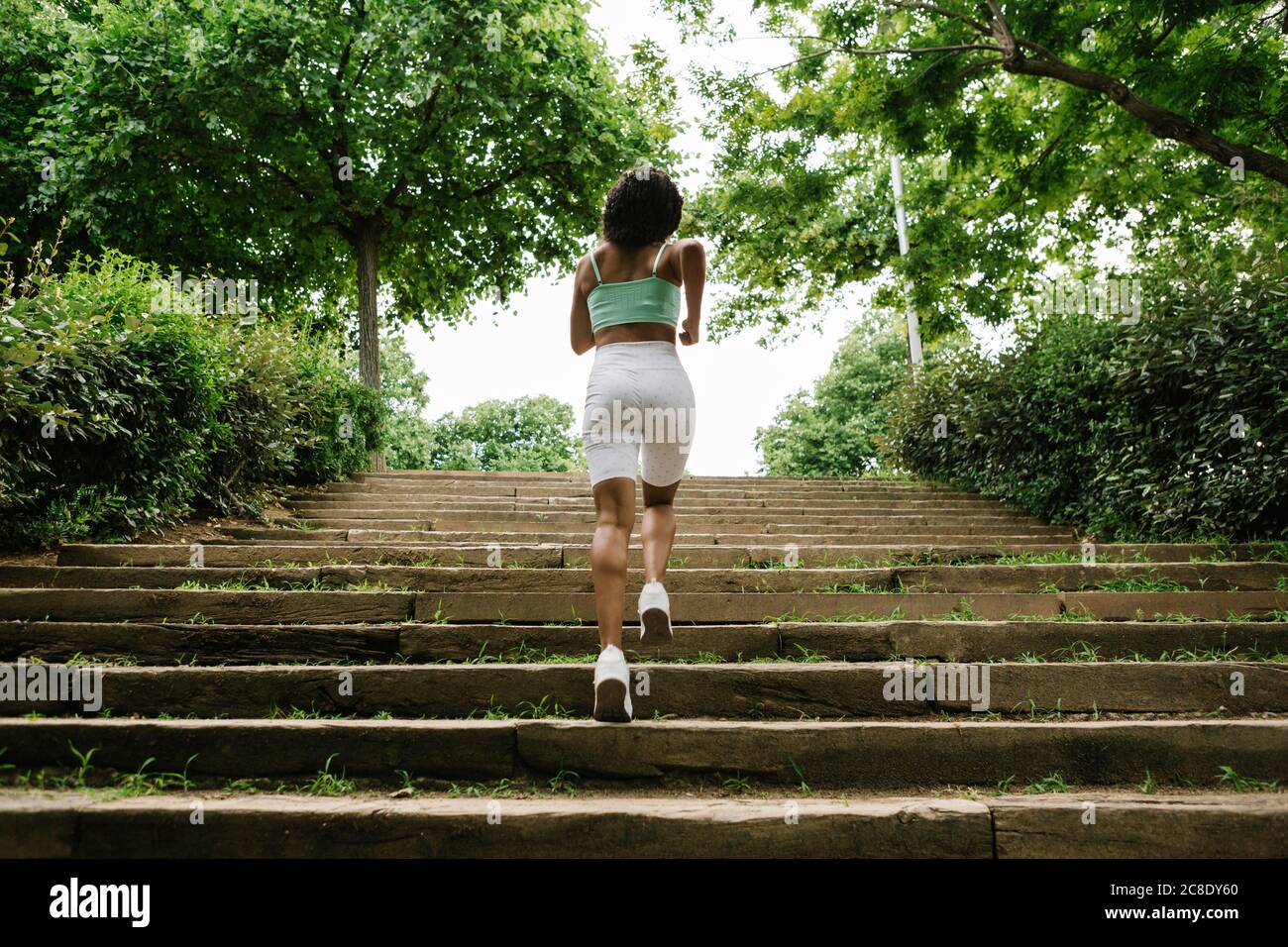 Rear view of female jogger on steps Stock Photo - Alamy