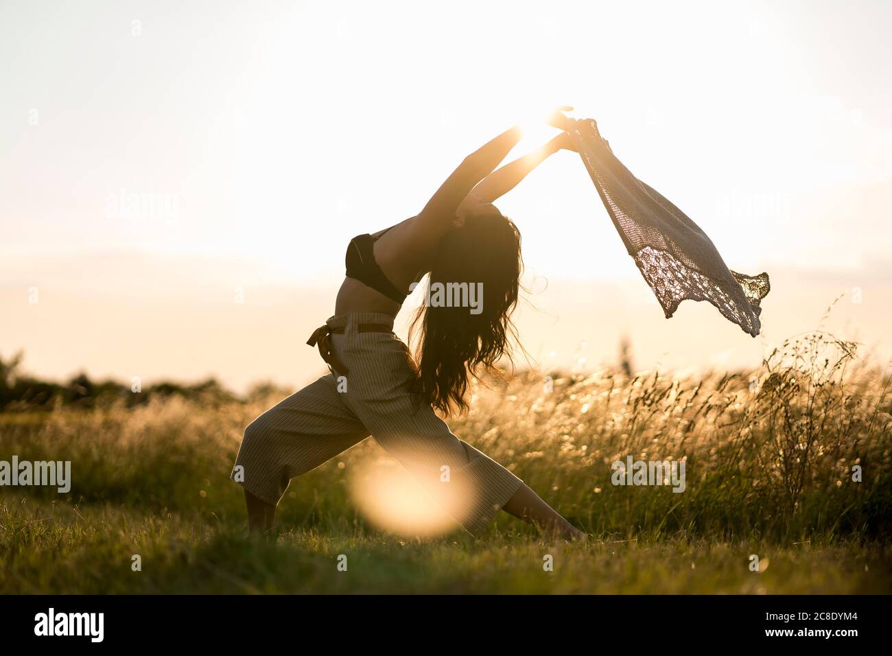 Woman dancing at field in the evening Stock Photo - Alamy