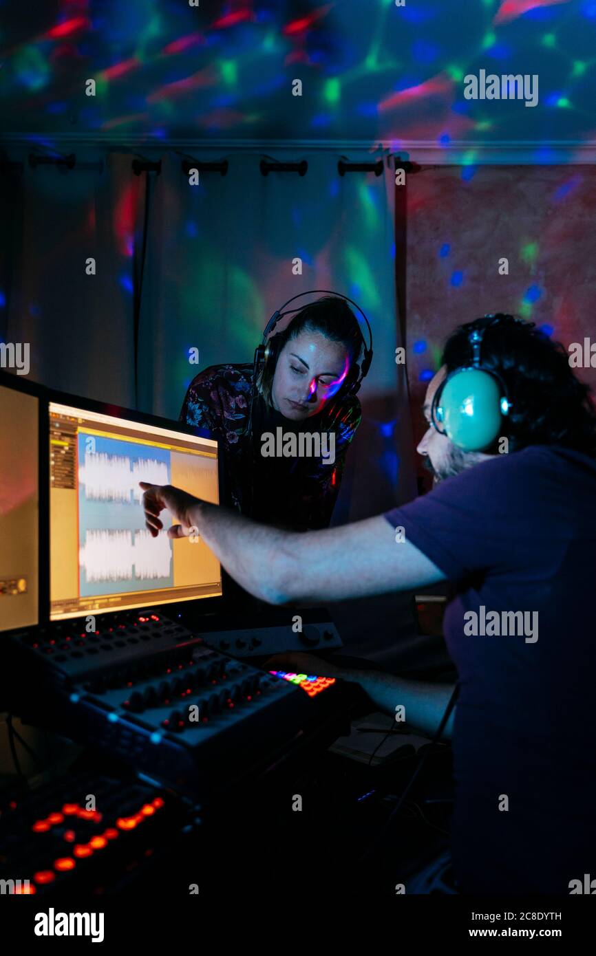 Musician couple using computer in recording studio at home Stock Photo ...