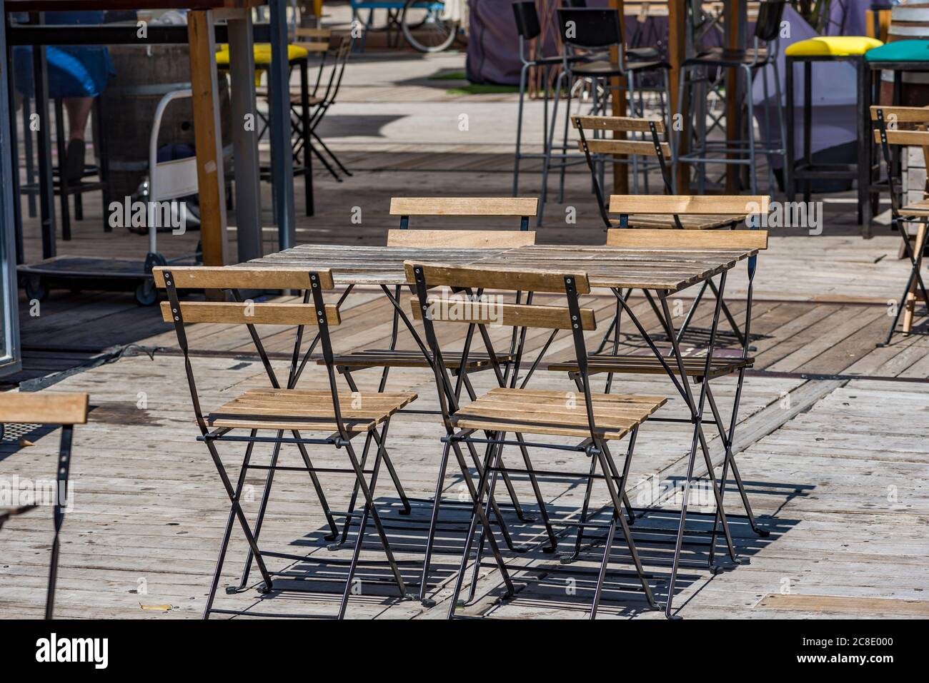 Wooden empty table for 4 persons of street cafe Stock Photo - Alamy