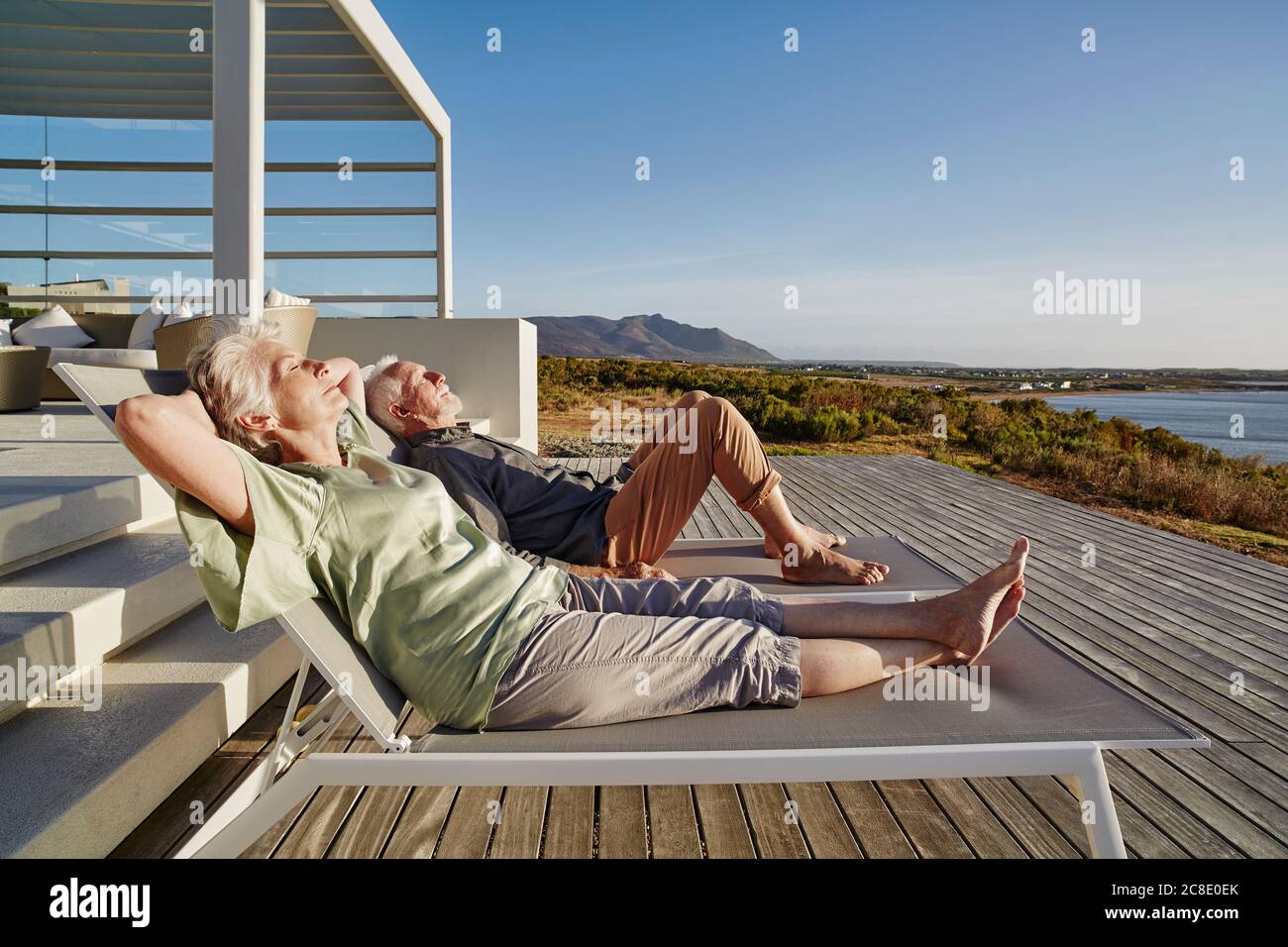 People lying on deck chairs hi-res stock photography and images - Alamy