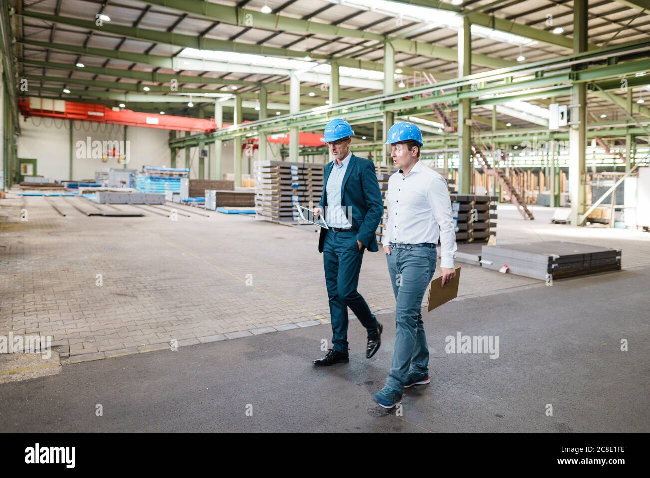 Two businessmen having meeting factory hall hi-res stock photography ...