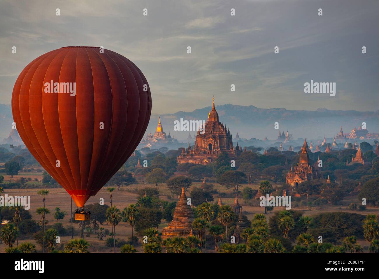 Myanmar, Mandalay Region, Bagan, Hot air balloon flying over Buddhist ...