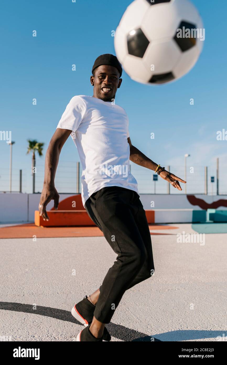 Young man playing soccer hi-res stock photography and images - Alamy