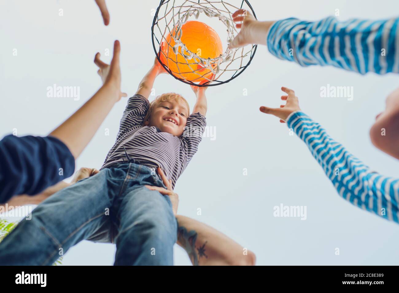 Group of children playing basketball hi-res stock photography and ...