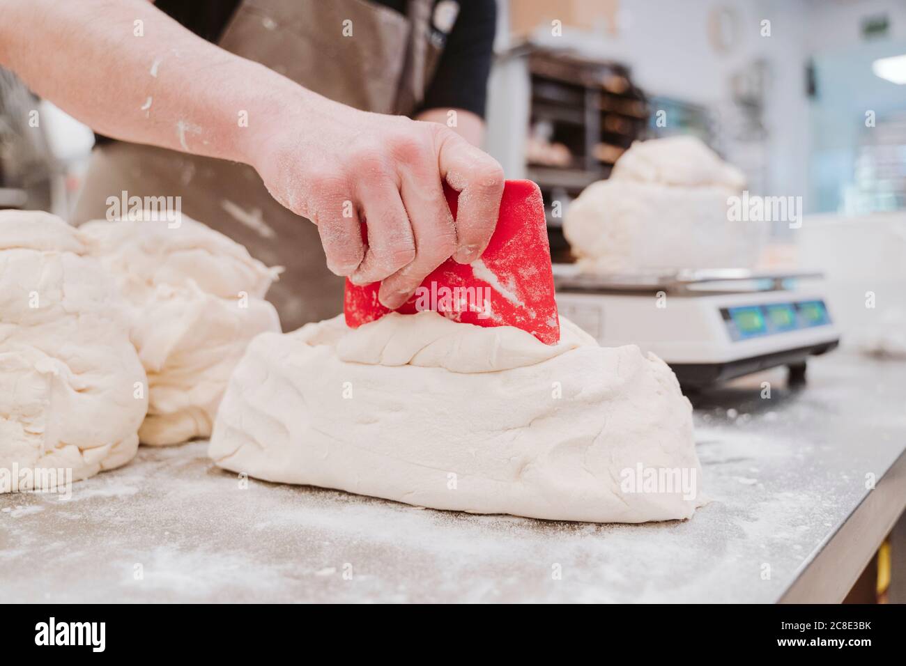 Female baker preparing bread loaf at kitchen counter in bakery Stock ...