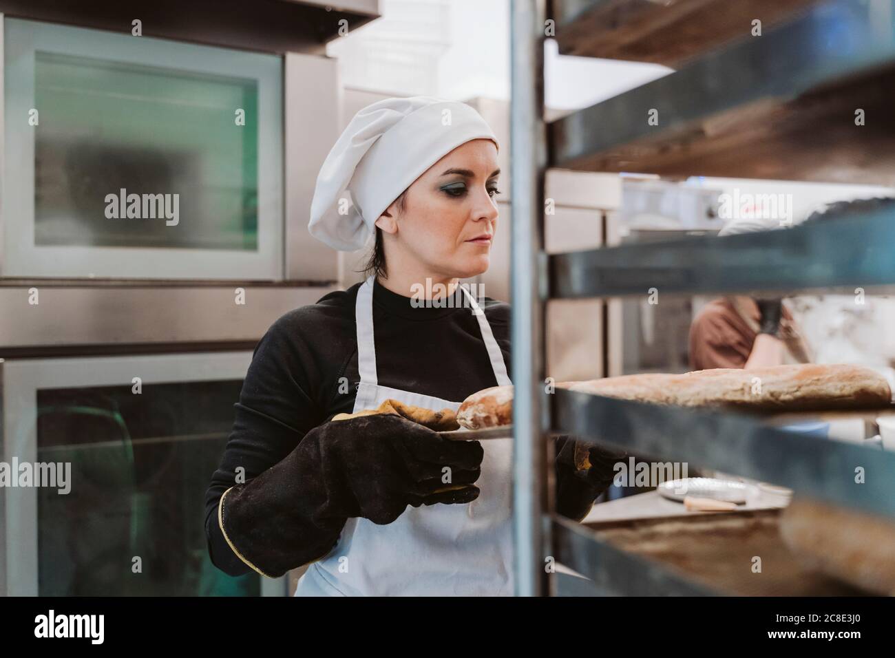 Female baker oven hi-res stock photography and images - Alamy