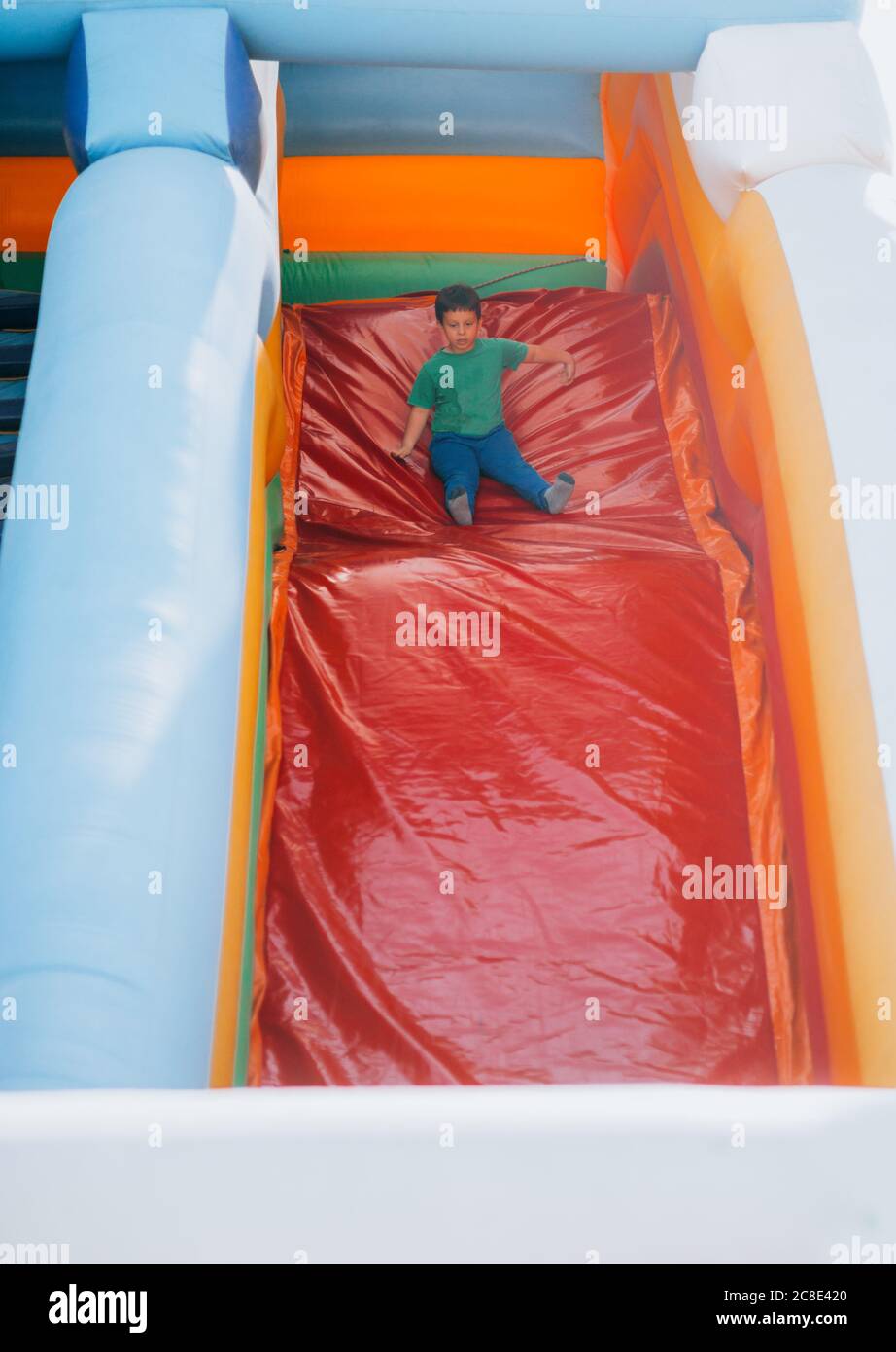 Happy little smiling boy climbing to slide at an amusement park Stock ...