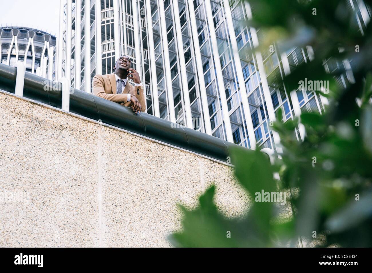Elegant businessman leaning railing city hi-res stock photography and ...