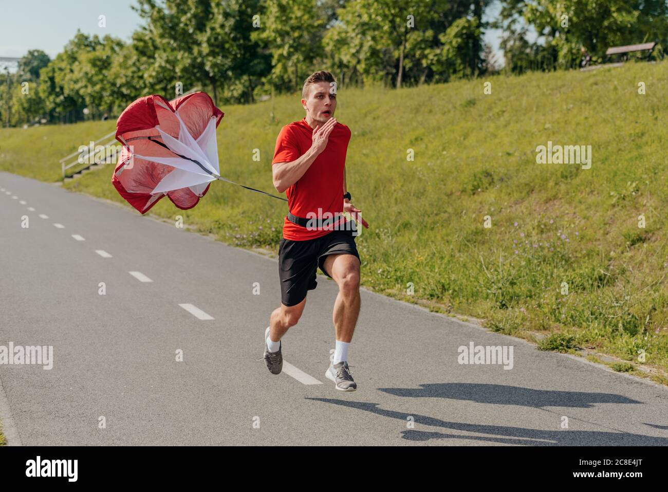 Athlete man running with parachute hi-res stock photography and images ...