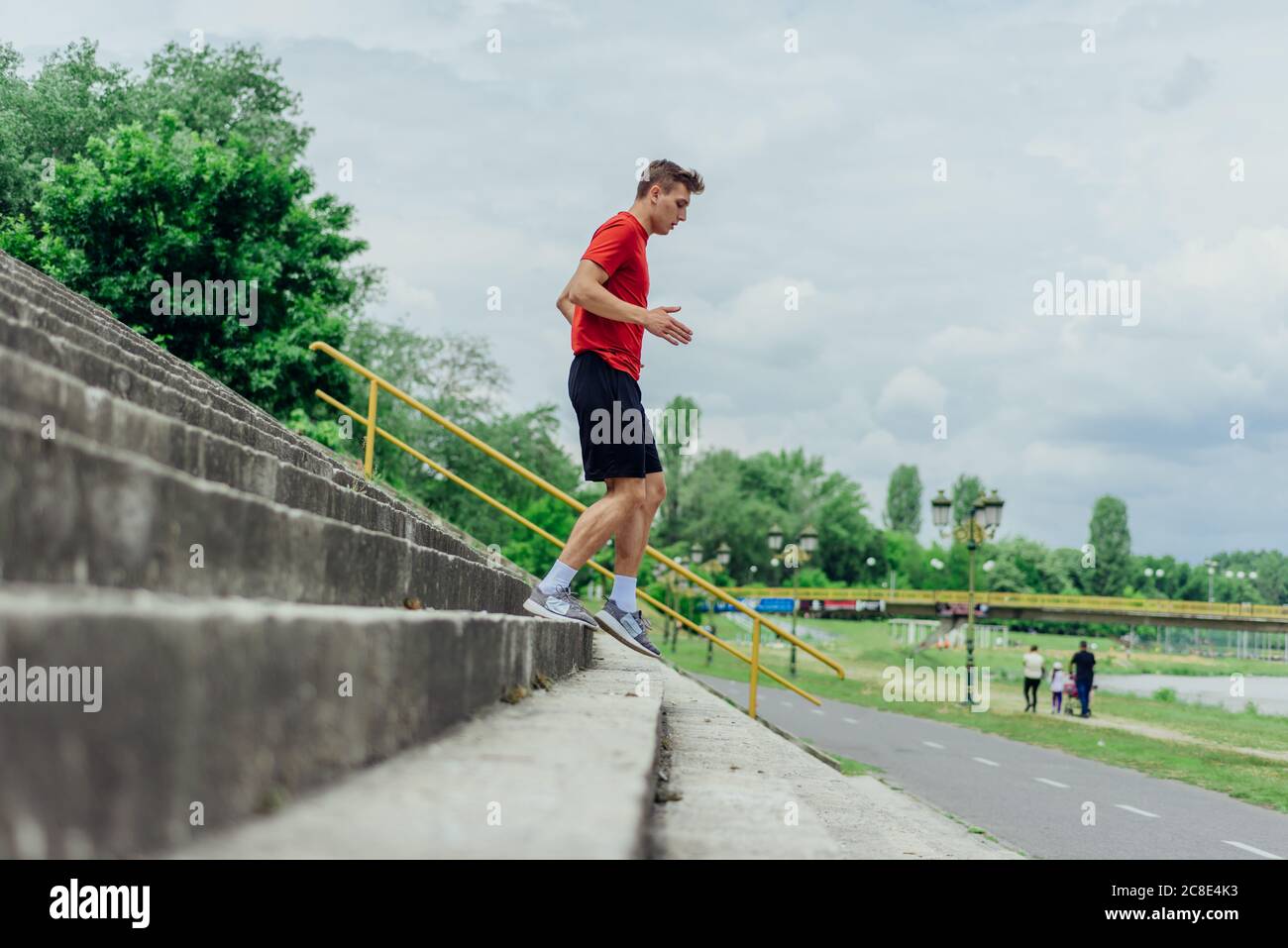 Fit male athlete performing stairs workout, running up climbing stairs ...