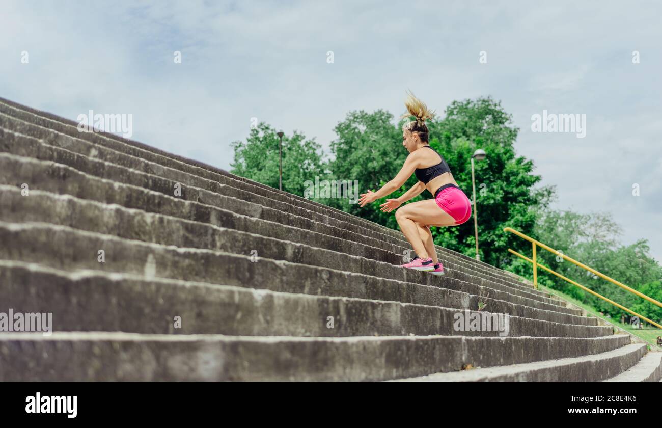 Fit healthy athlete, beautiful woman in tight sportswear jumping on ...